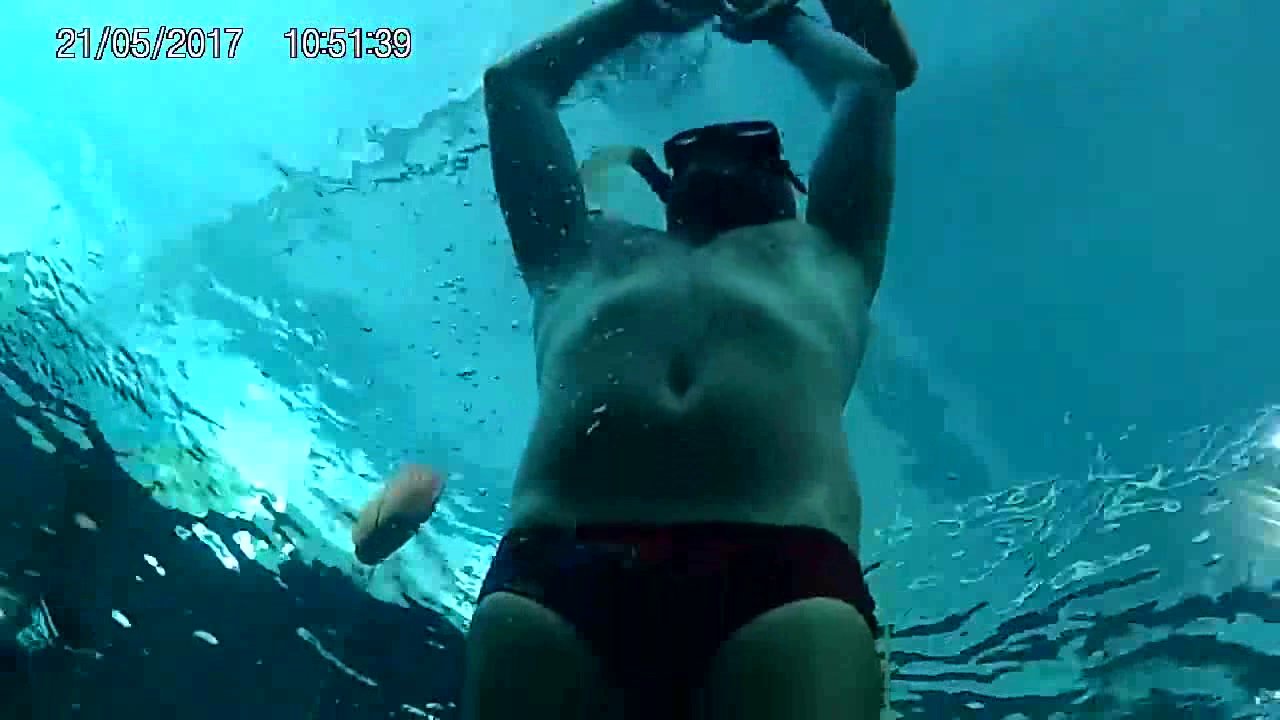 Bald Guy Underwater In Speedos