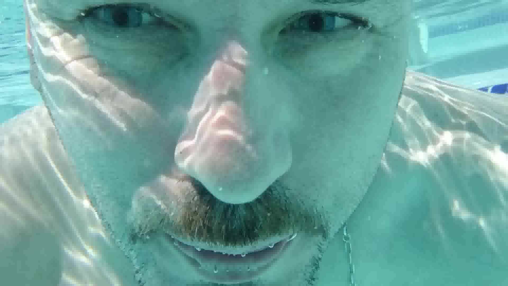 Bald Guy Barefaced Underwater In Pool