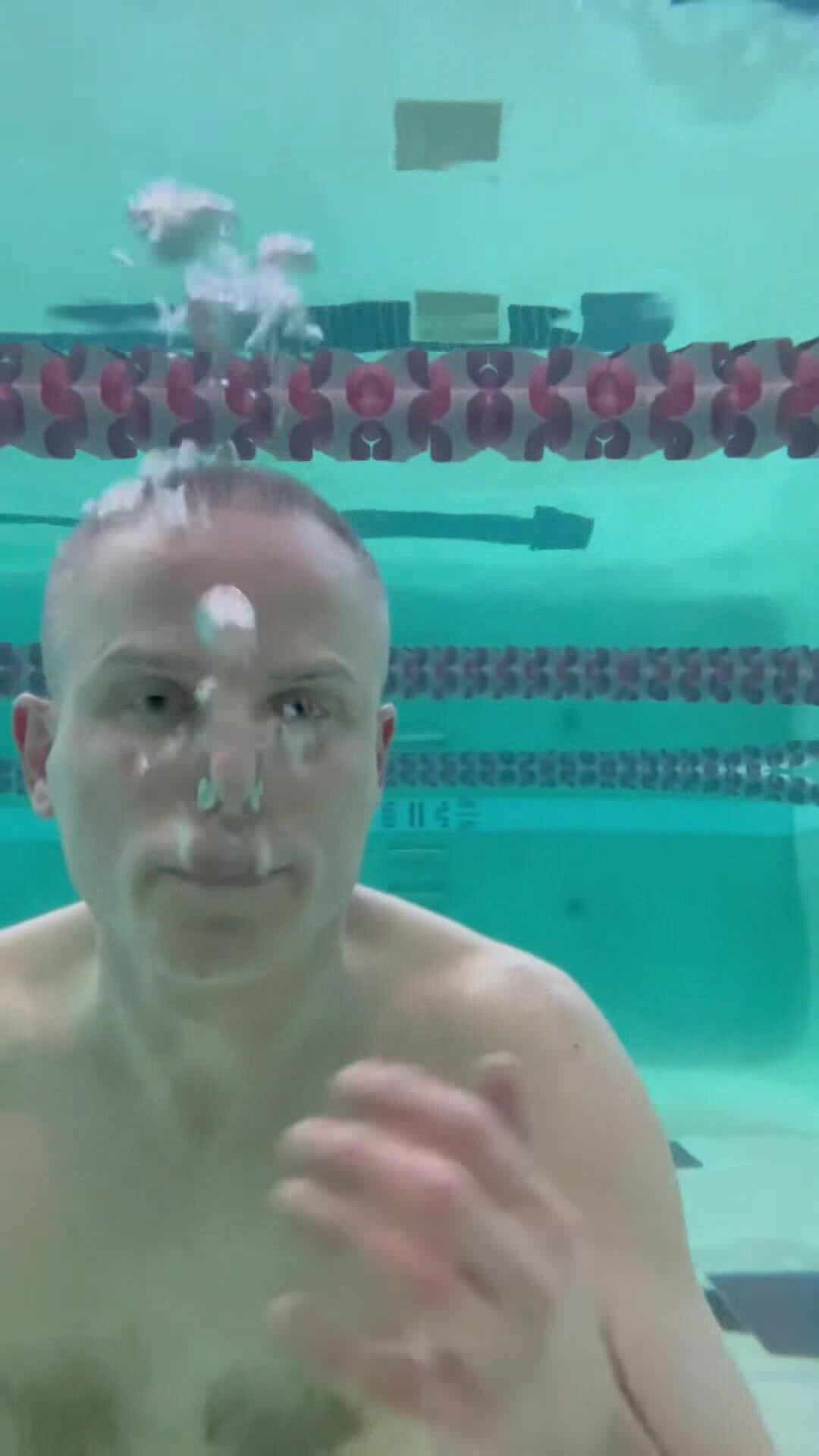 Floating Barefaced Underwater In Speedos